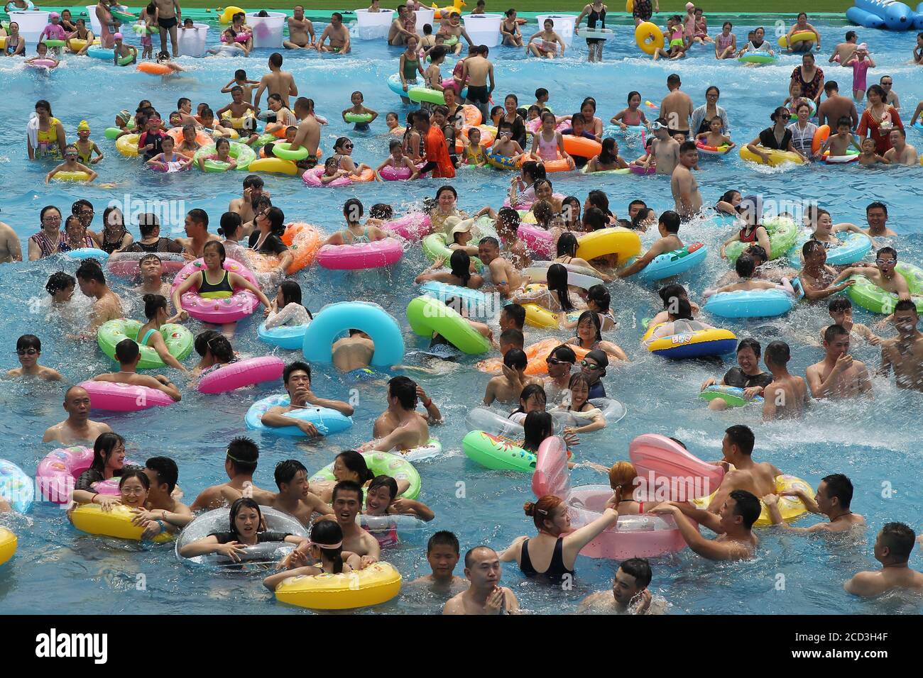 People play in the water at a water park in Chongqing, China, 25 July ...