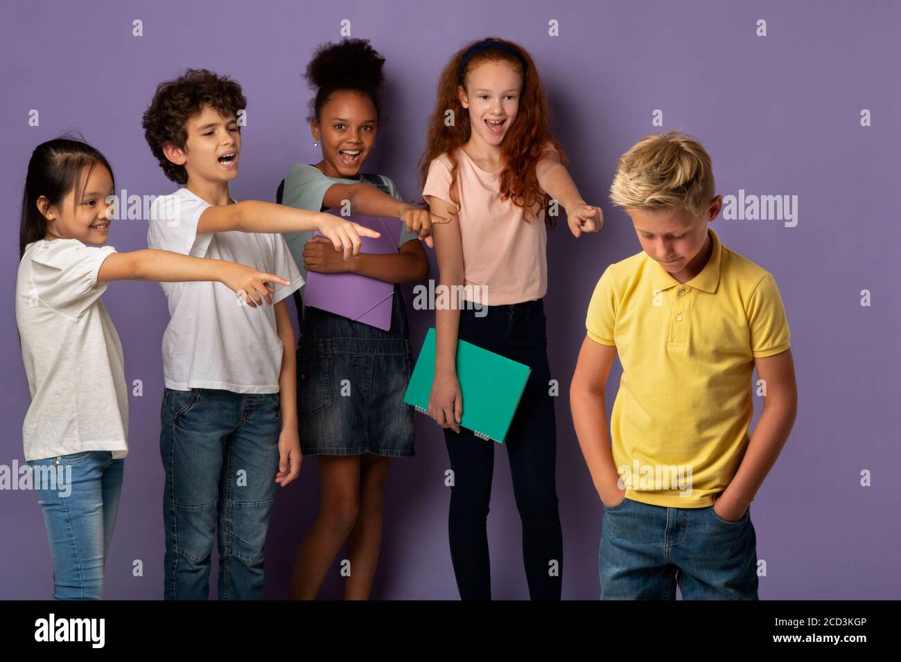 No to bullying. Diverse schoolchildren laughing at sad blonde boy over ...