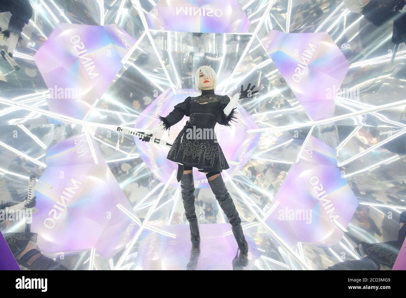 Beautiful cosplayers are seen posing and performing in clothes shown in ...