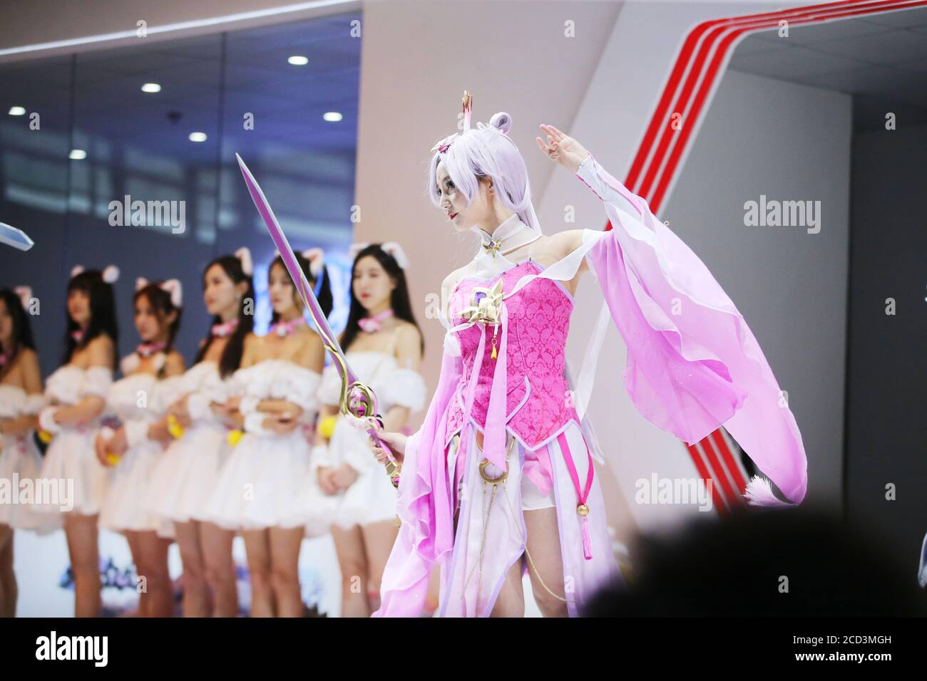 Beautiful cosplayers are seen posing and performing in clotThes shown ...
