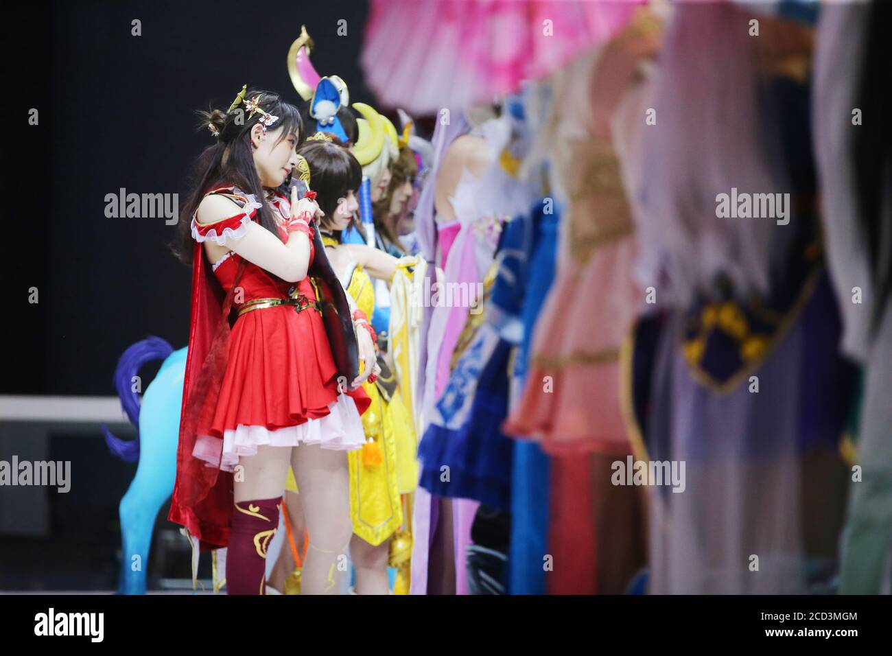 Beautiful cosplayers are seen posing and performing in clotThes shown ...