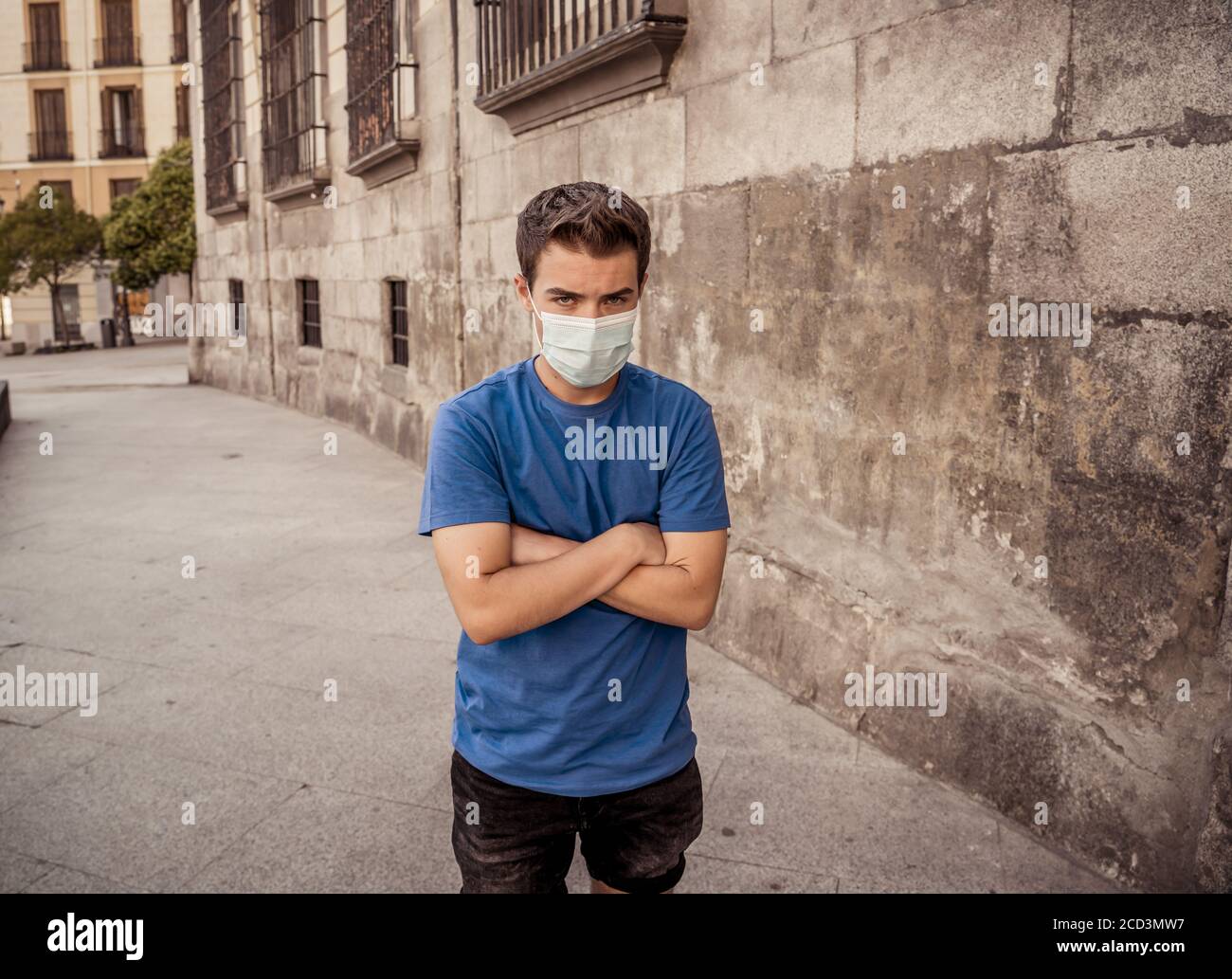 Young sad desperate man wearing surgical face mask in public spaces ...