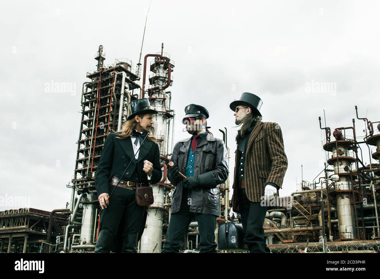 Three mans in steampunk style discuss standing against the industrial ...