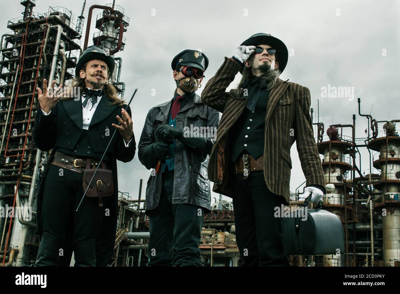 Three mans in steampunk style discuss standing against the industrial ...