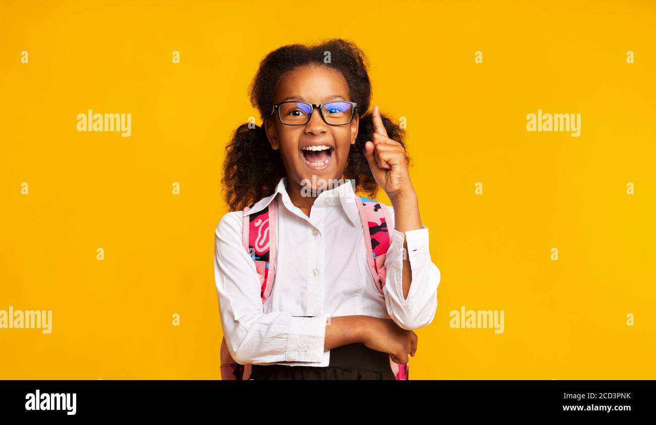 Joyful School Kid Girl Pointing Finger Up Standing, Studio Shot Stock ...