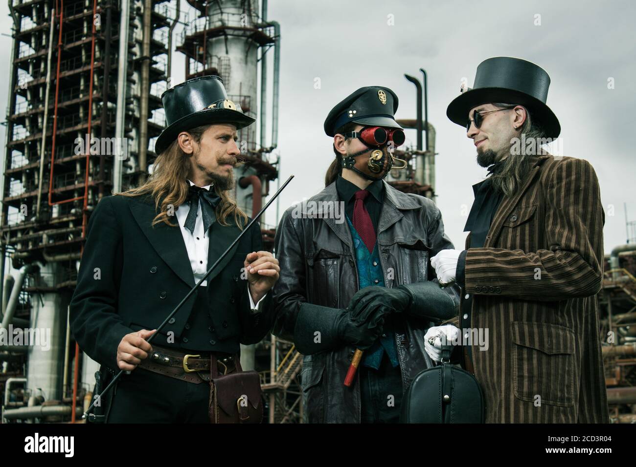 Three mans in steampunk style discuss standing against the industrial ...
