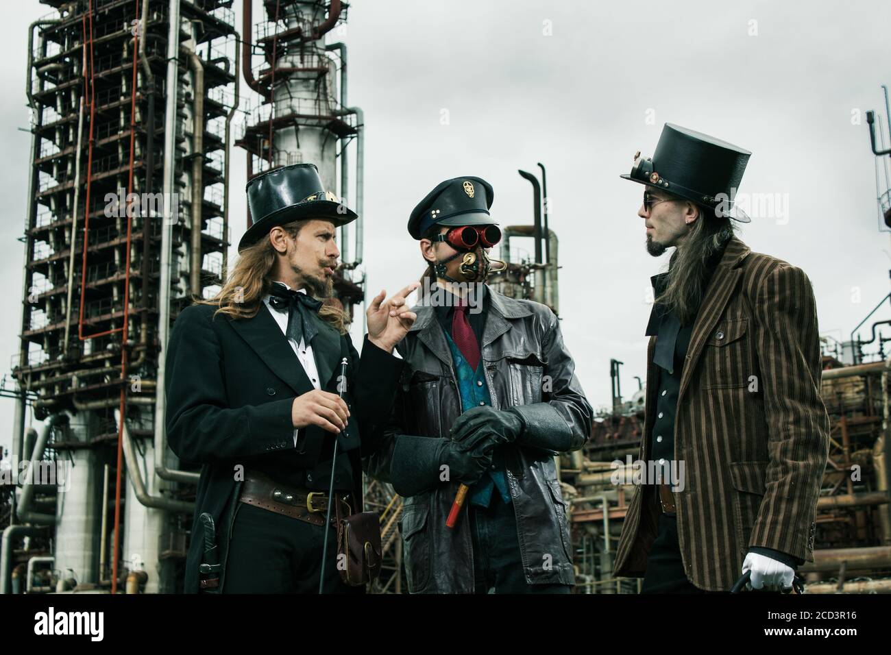 Three mans in steampunk style discuss standing against the industrial ...