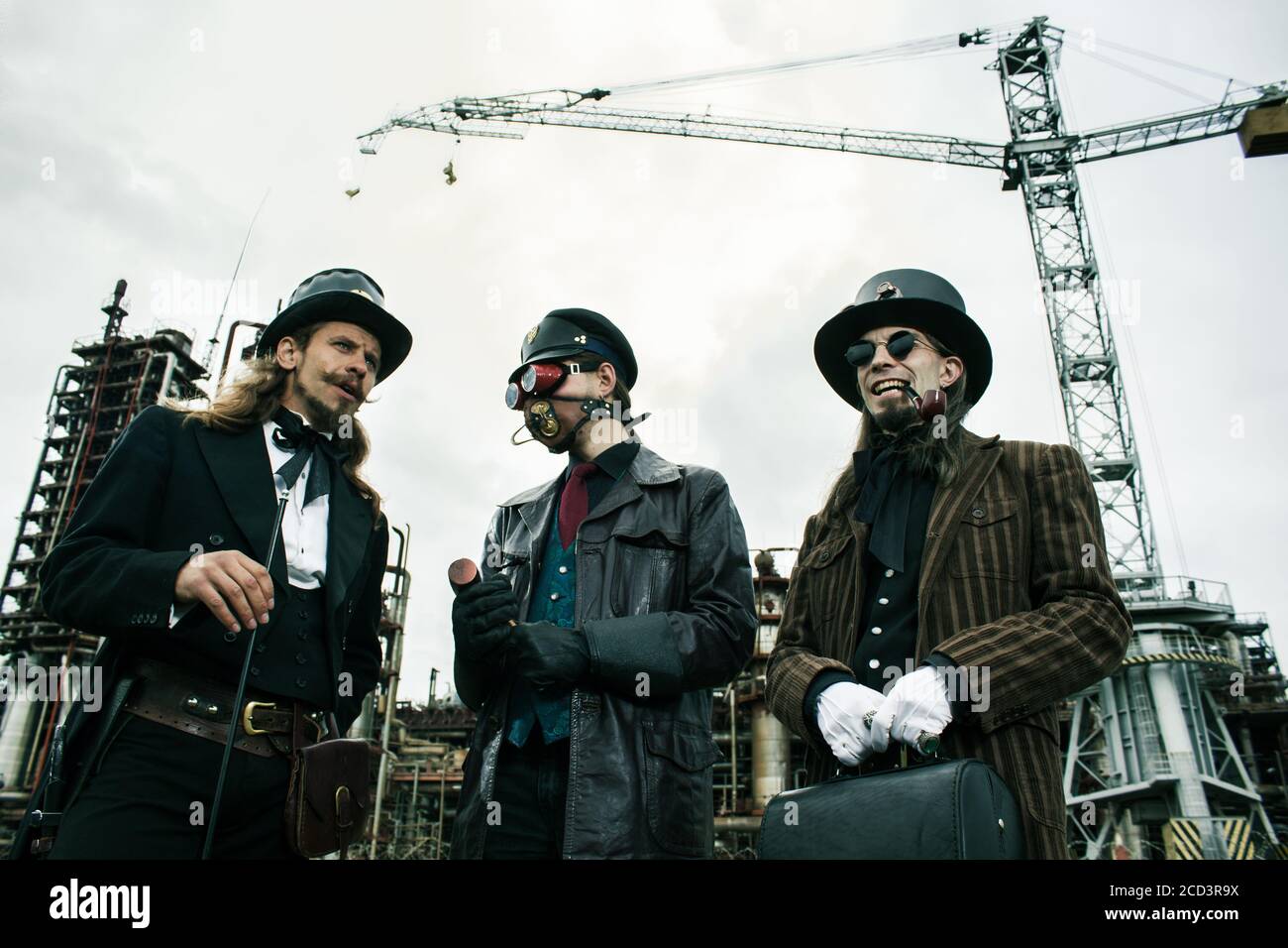 Three mans in steampunk style discuss standing against the industrial ...