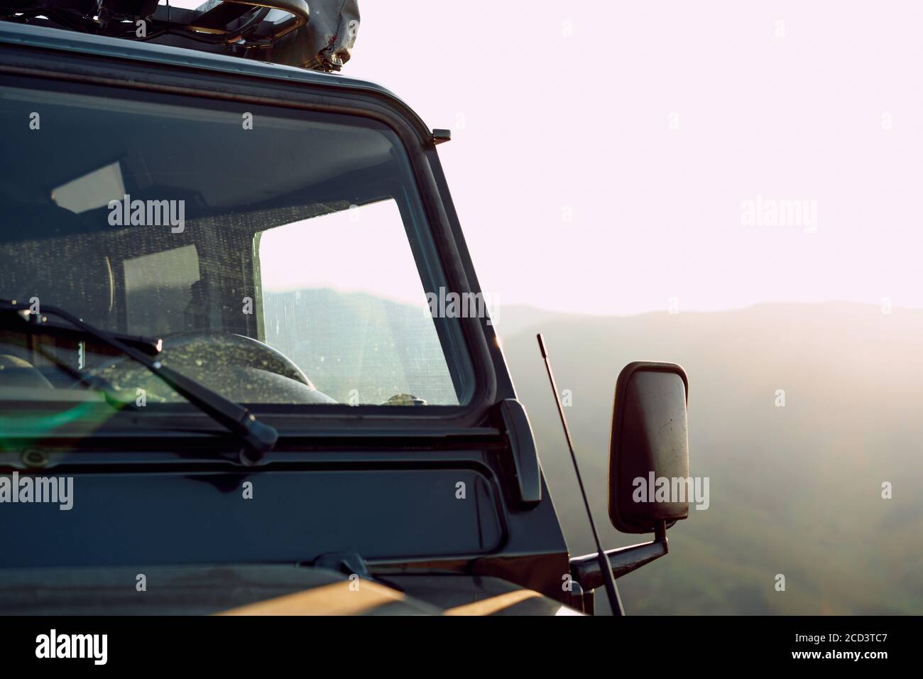 Dark green off-road car in the mountains Stock Photo - Alamy