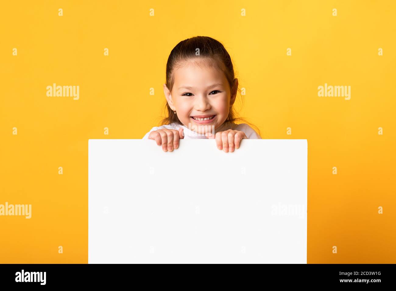 Asian kid hiding behind blank white advertising billboard Stock Photo ...
