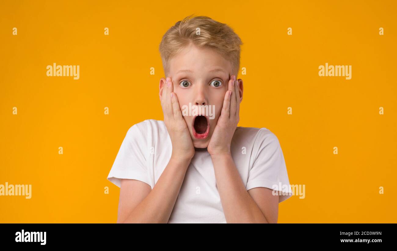 Surprised shocked little boy looking at camera Stock Photo - Alamy