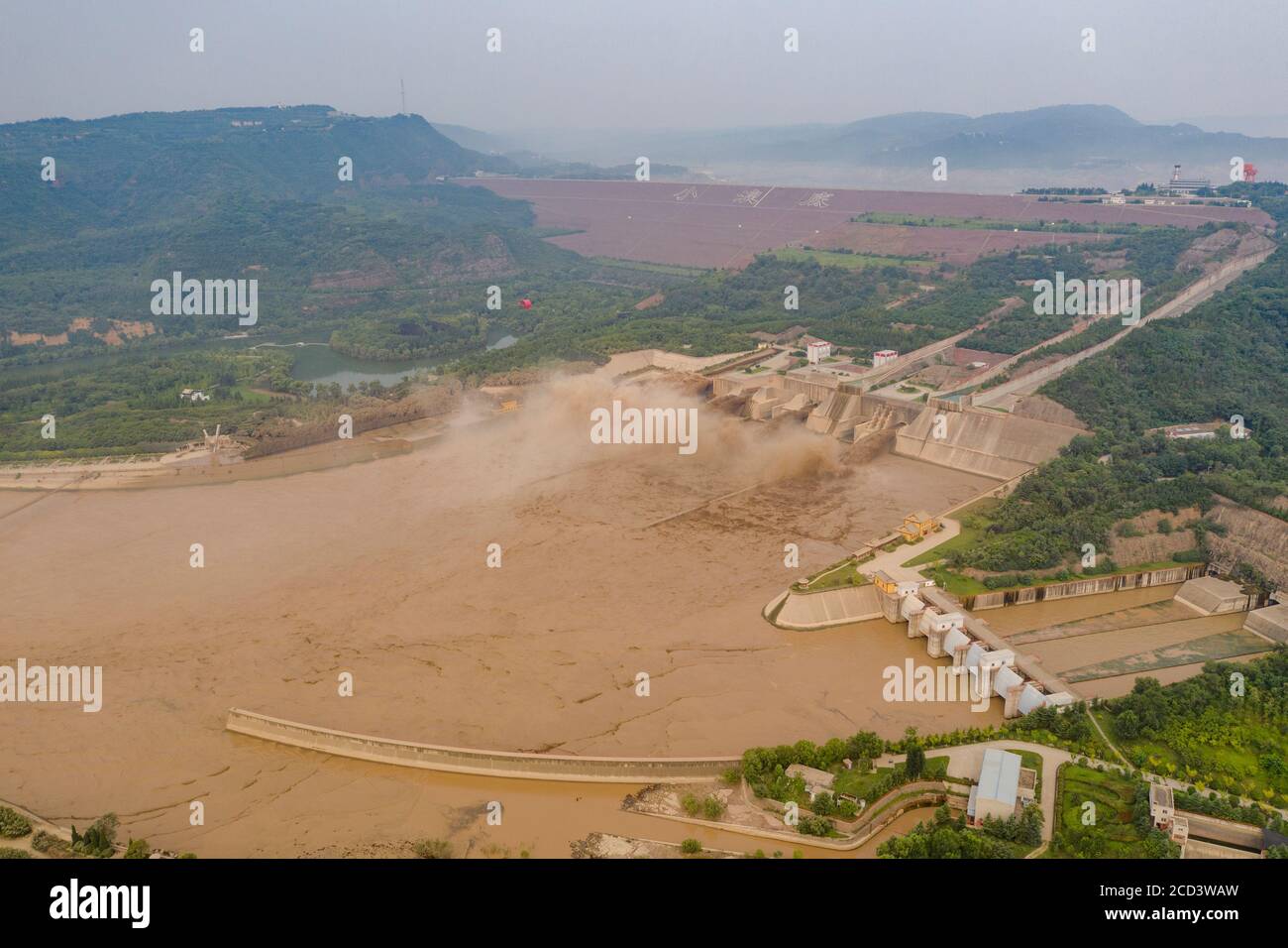 Aerial view of Xiaolangdi Dam discharging flood and sand after days of ...