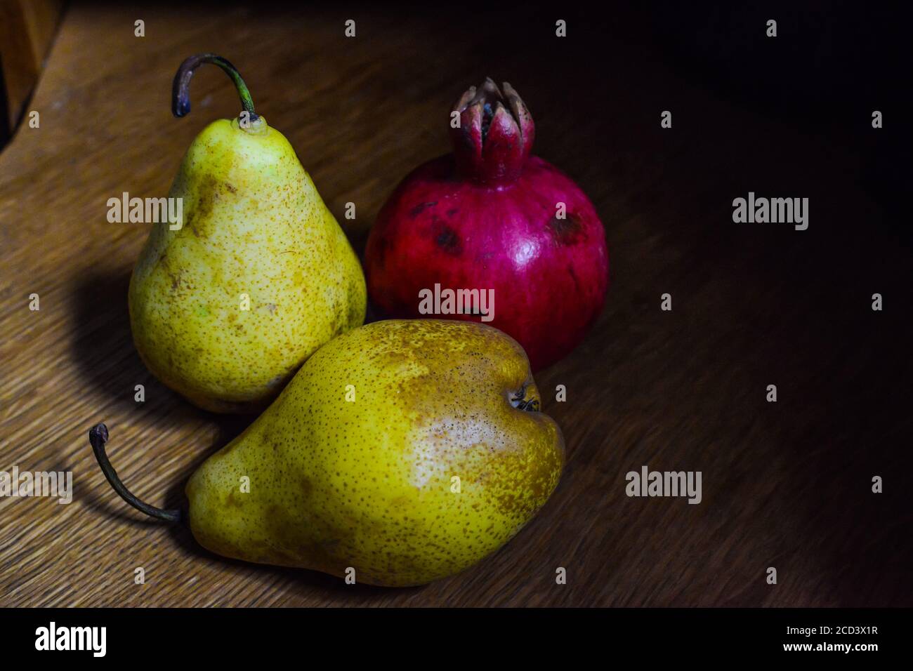 A couple of Fresh ripe organic yellow pears and one pomegranate on ...