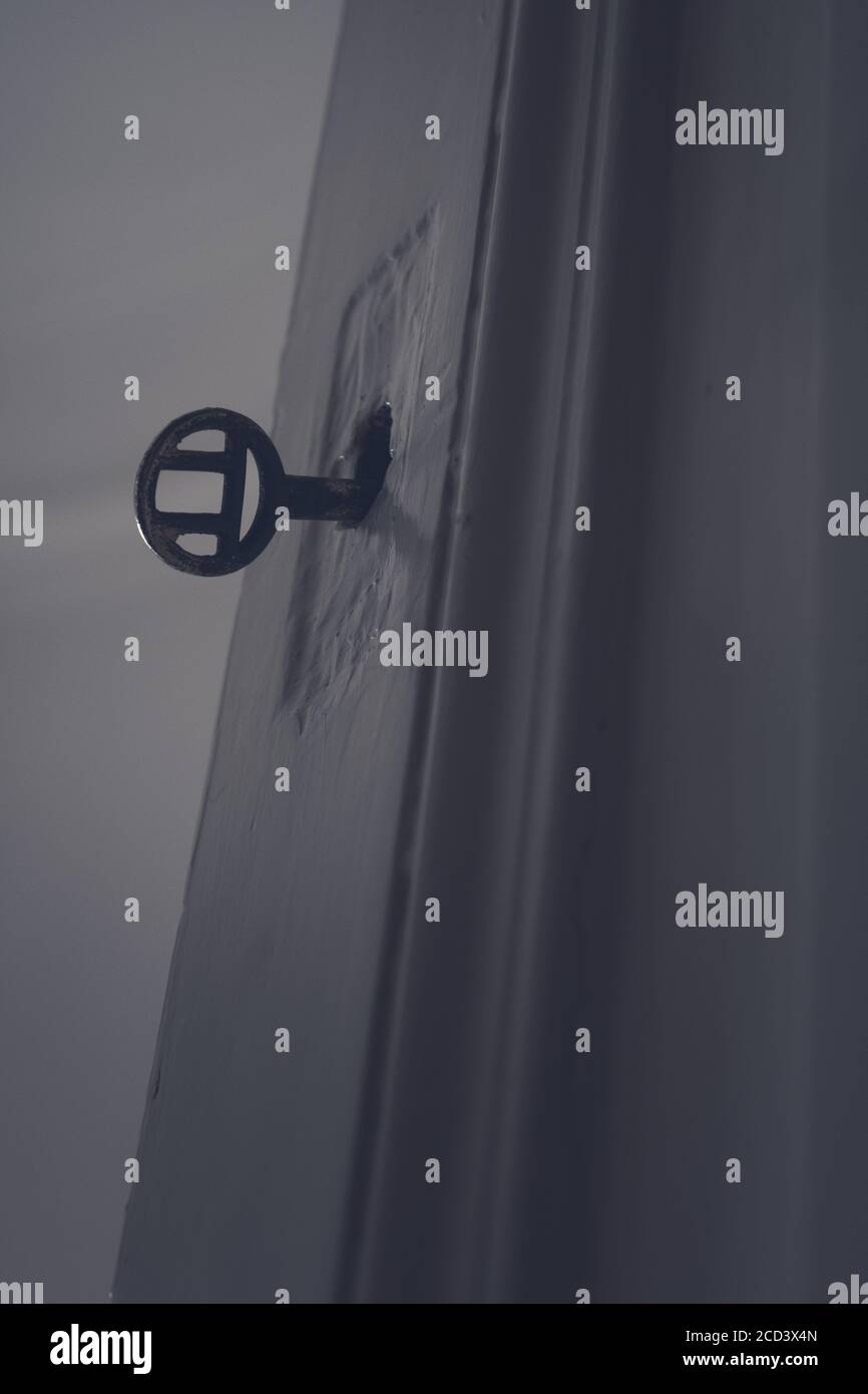 Vertical shot of a key in the lock Stock Photo - Alamy