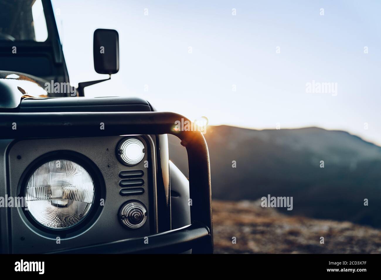 Dark green off-road car in the mountains Stock Photo - Alamy