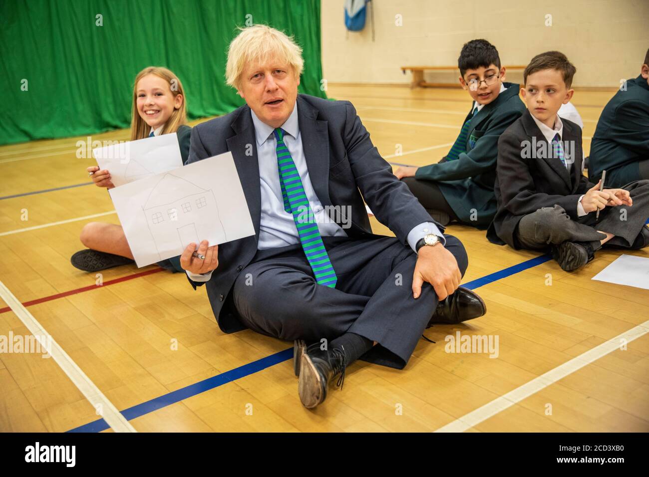 Prime Minister Boris Johnson with Olivia Stokes in the gym taking part ...