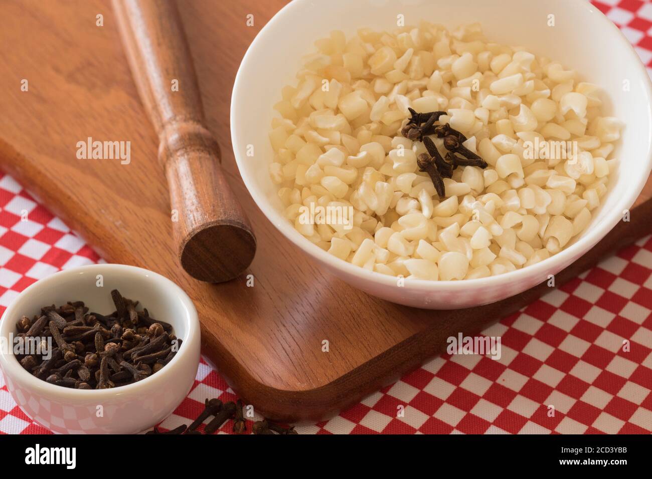Brazilian dessert sweet canjica of white dry corn with clove in bowl ...