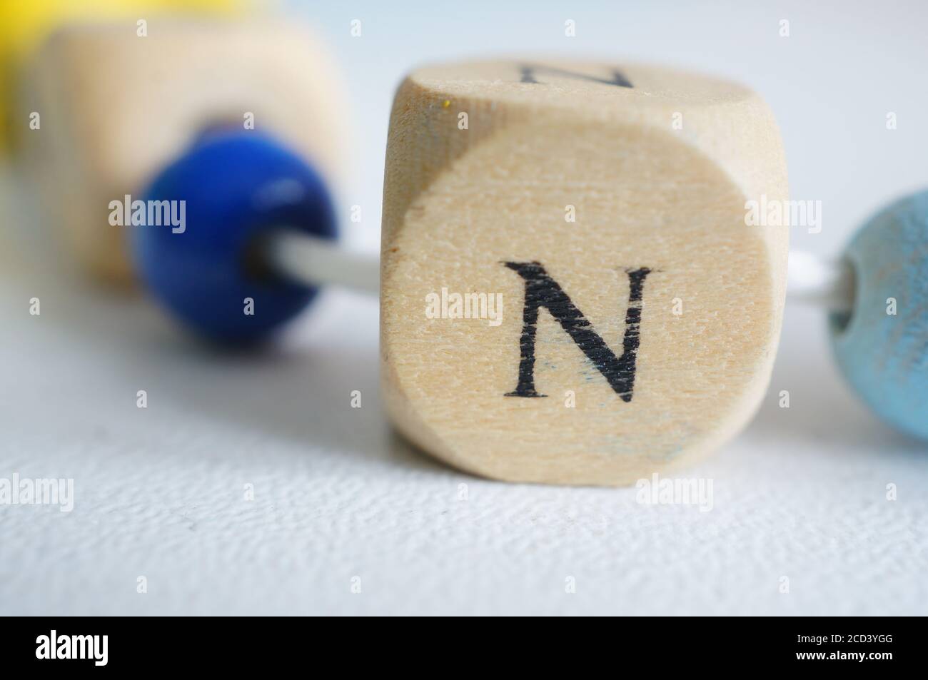 Closeup shot of beads and a cube with the letter "N Stock Photo - Alamy