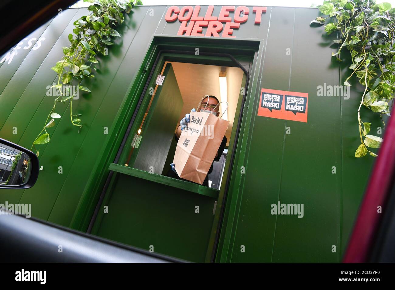 A member of staff hands out a meat-free burger a meat-free burger from ...