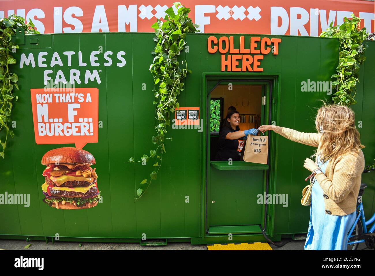 A customer collects a meat-free burger from the M*** F*** Drive Thru ...