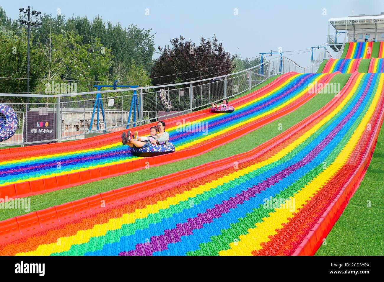 People experience the new rainbow slide at the Wukesong Adventure Park ...