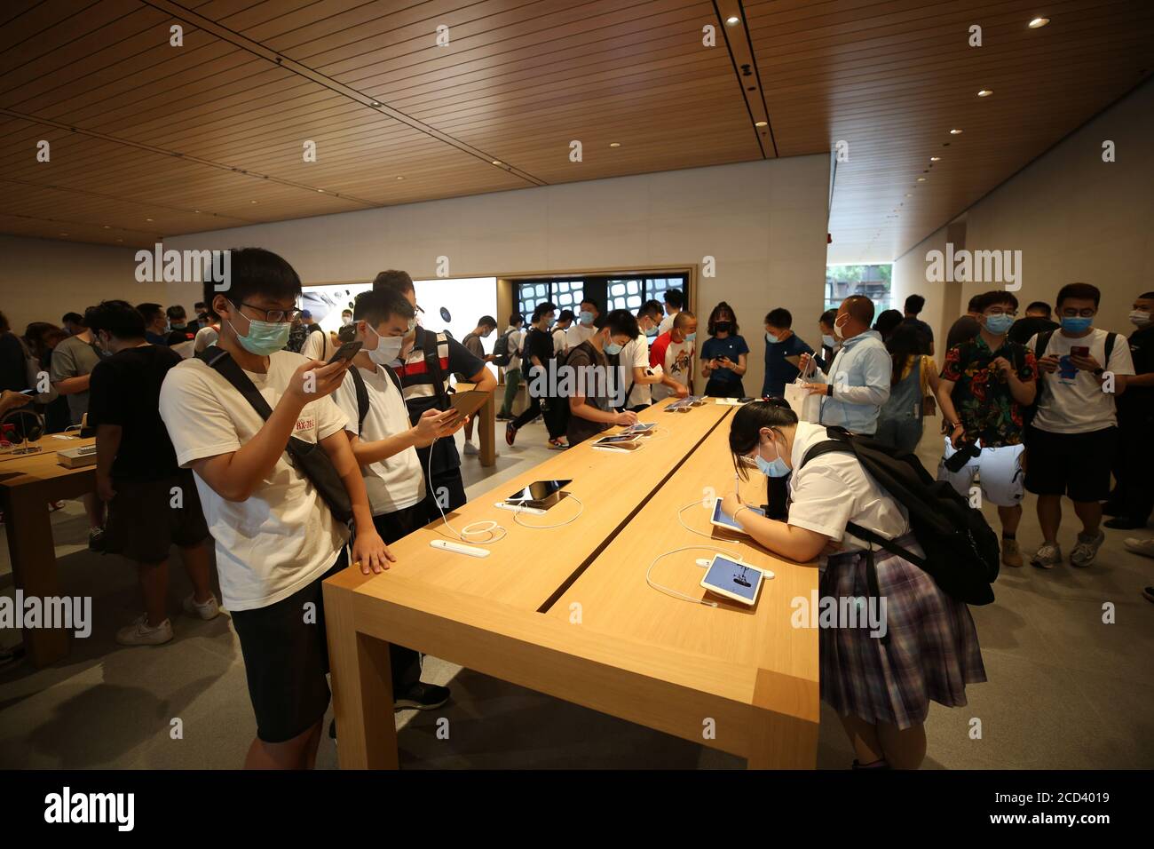 People experience Apple products at the newly-opened Apple Store at ...