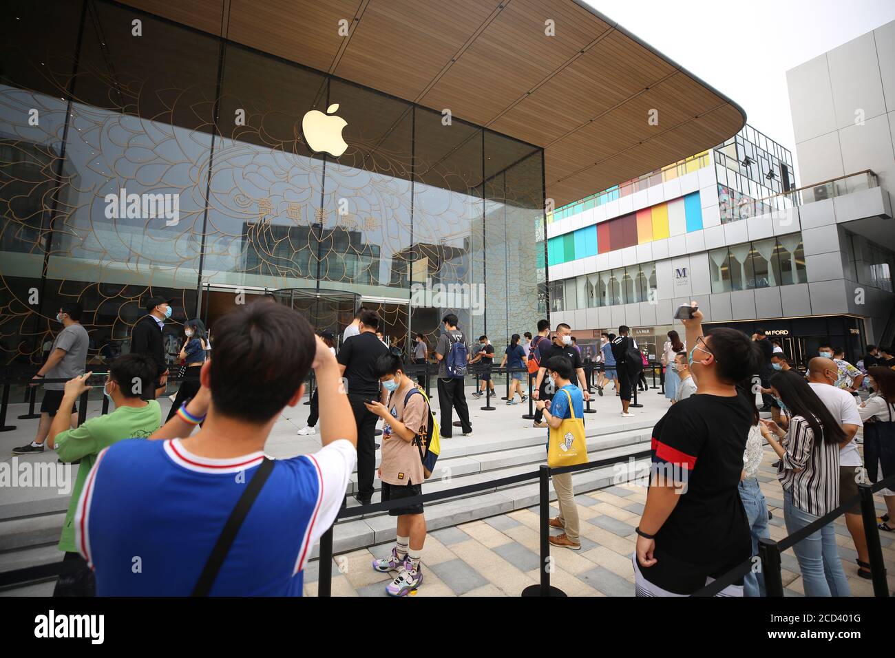 People take photos of Apple logo at the newly-opened Apple Store at ...