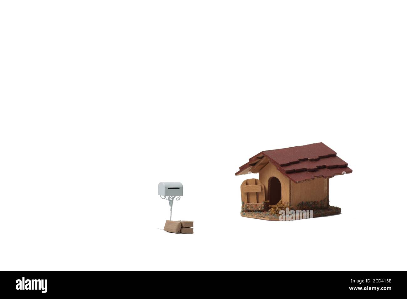 a letter box and wrapped box near a house isolated on white background ...