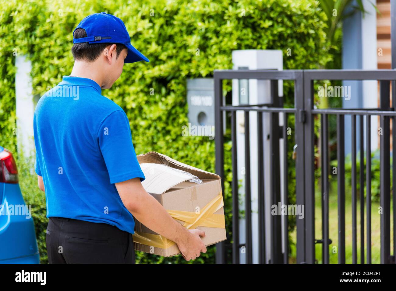 Asian young delivery man in blue uniform he emotional falling courier ...