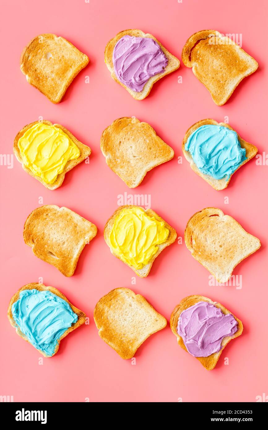 Pattern of toast bread with colored cheese spread. Layout top view ...