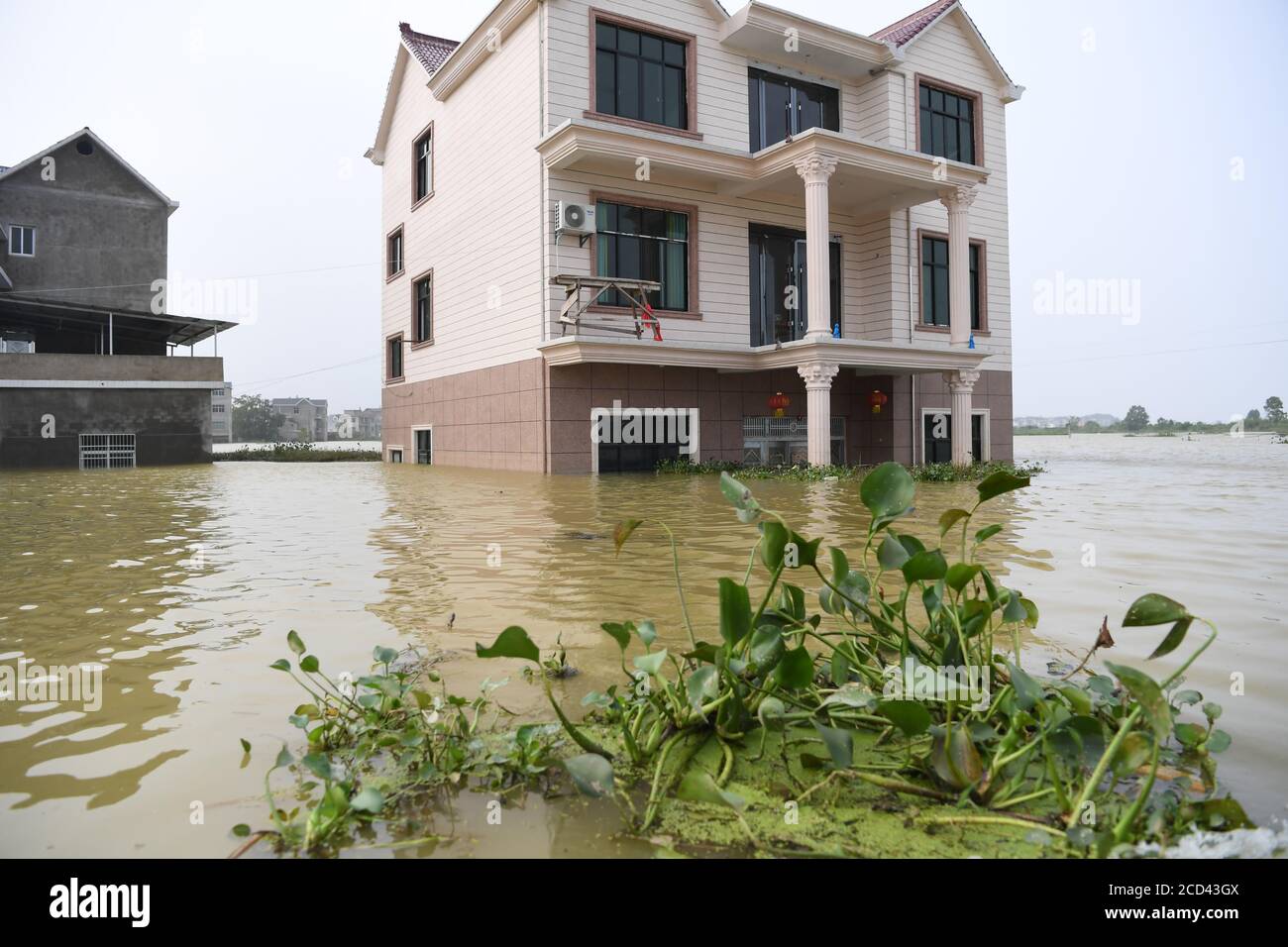A building is flooded due to continuous rainfall in Youdun village ...
