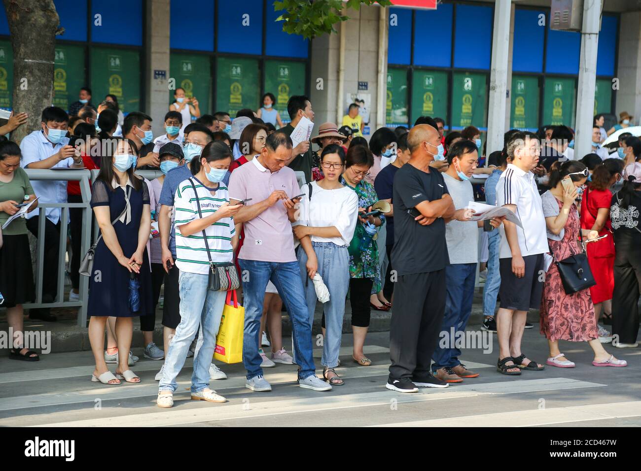 Parents wait for their children outside a testing center in the ...