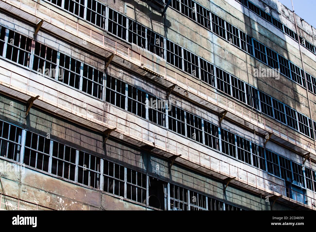 Old soviet abandoned metallurgy plant. Facade of factory building with ...