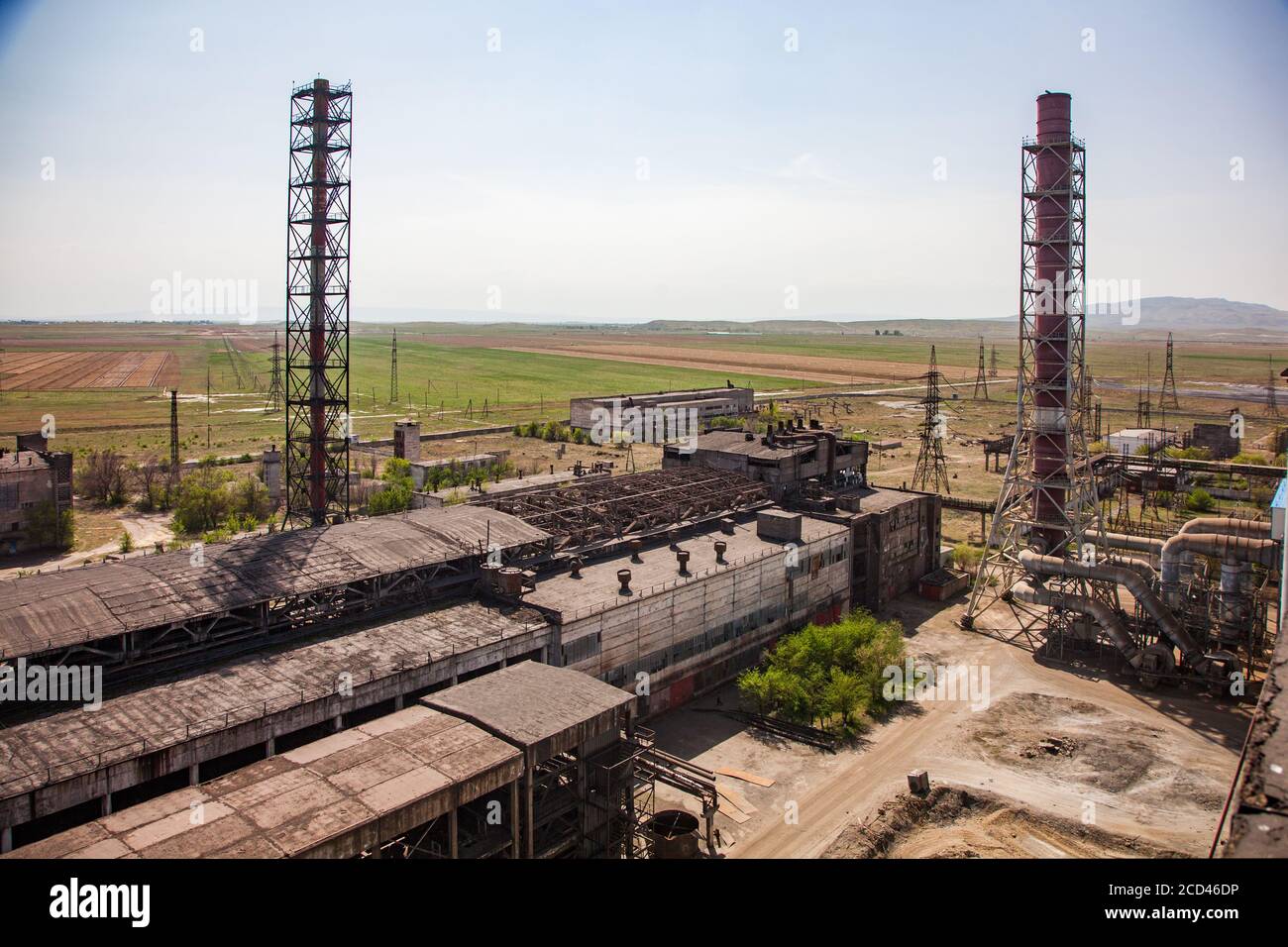 Abandoned metallurgy factory buildings and rusted factory chimneys on ...