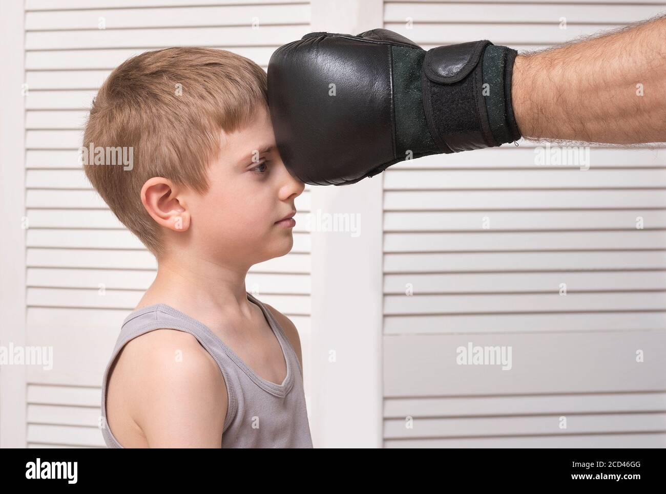 Man's hand in a boxing glove and defenseless child Stock Photo - Alamy