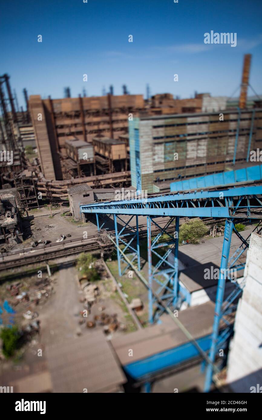 Old metallurgy factory buildings with blue conveyor and factory ...