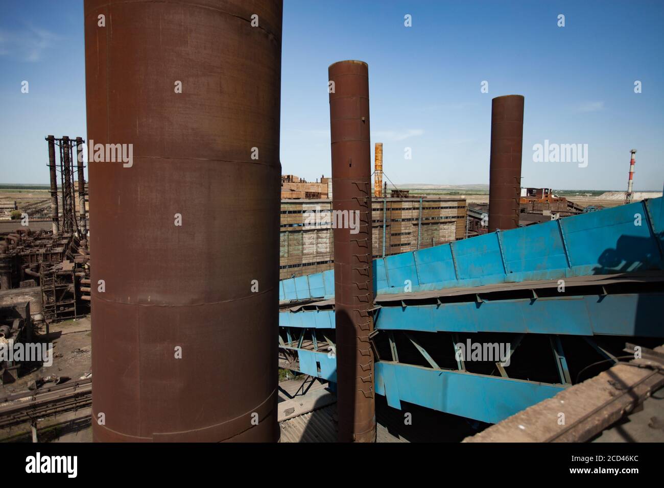 Abandoned soviet metallurgy factory buildings and rusted chimneys on ...