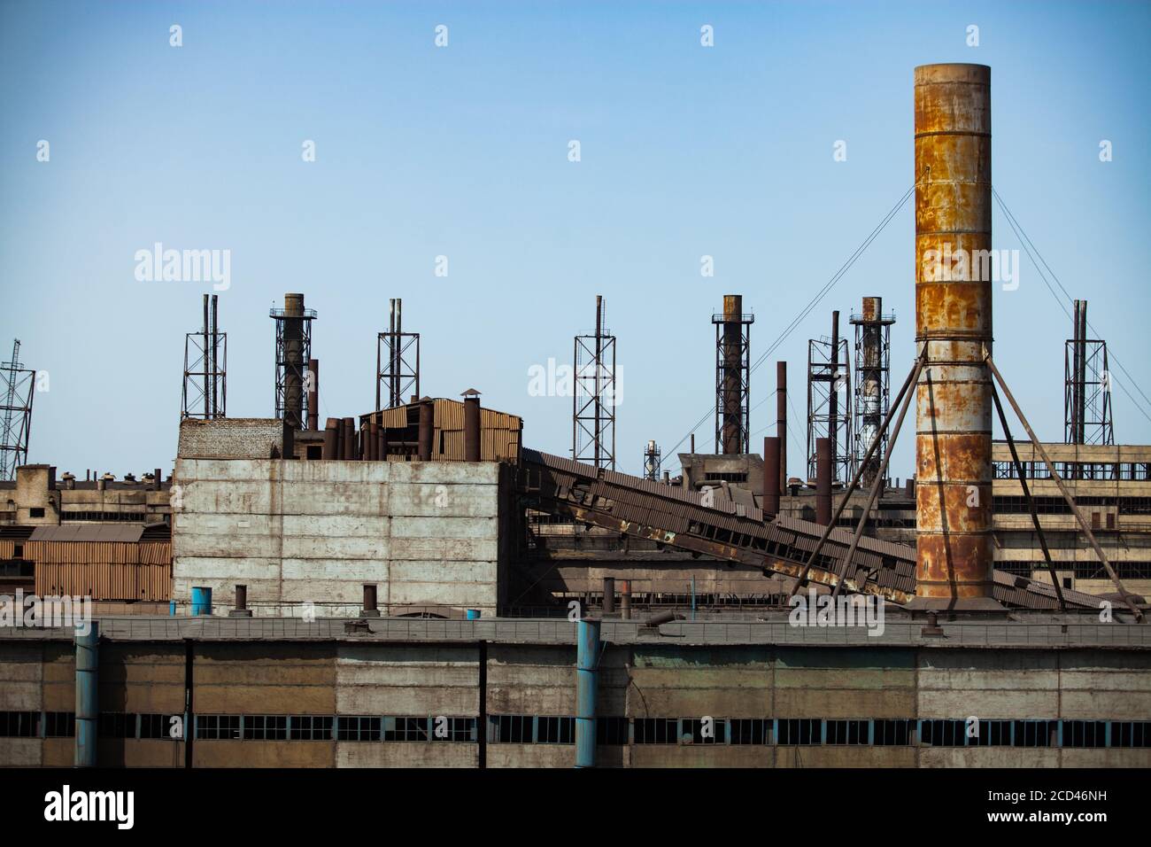 Abandoned soviet metallurgy factory buildings and rusted chimneys on ...