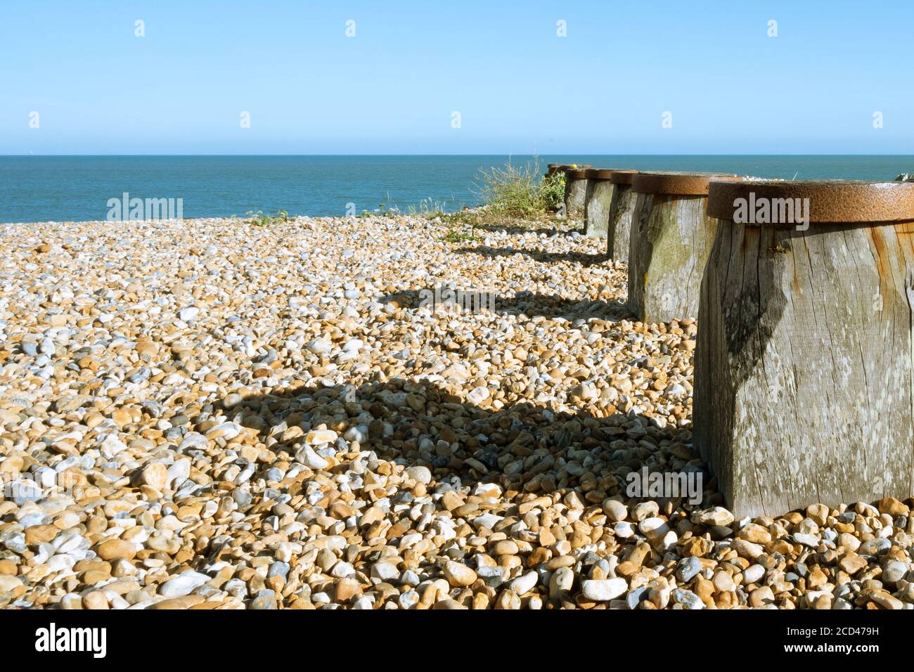 Beautiful view of pebble beach with groynes at daytime Stock Photo - Alamy