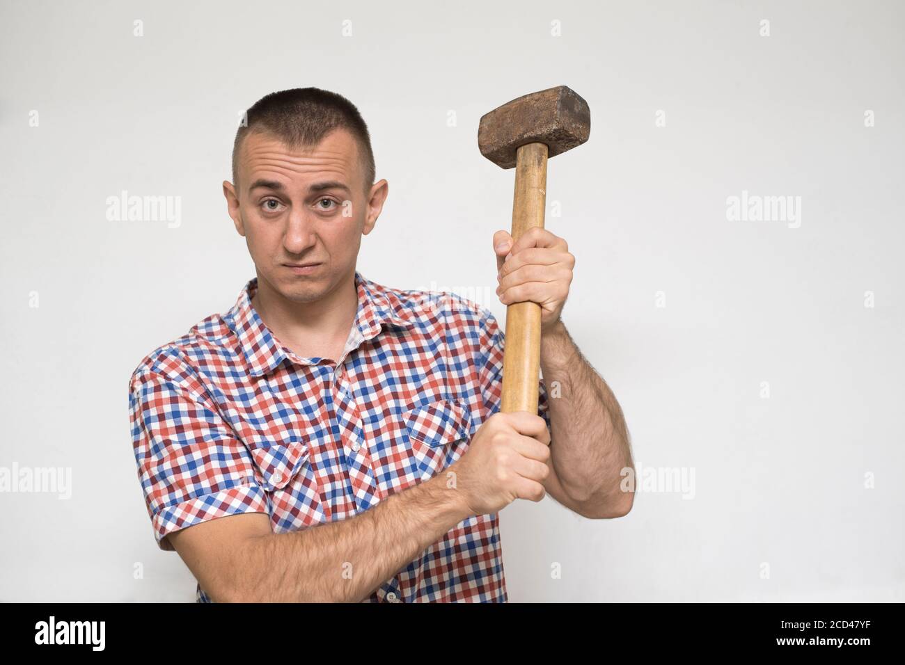Man with a sledgehammer on a white background. Work concept Stock Photo ...