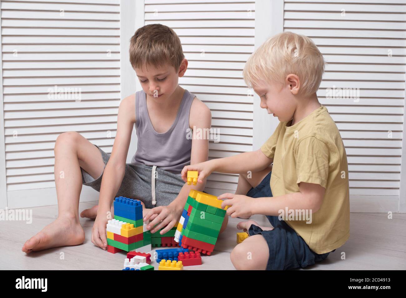 Two boys play a designer. Communication and friendship Stock Photo - Alamy