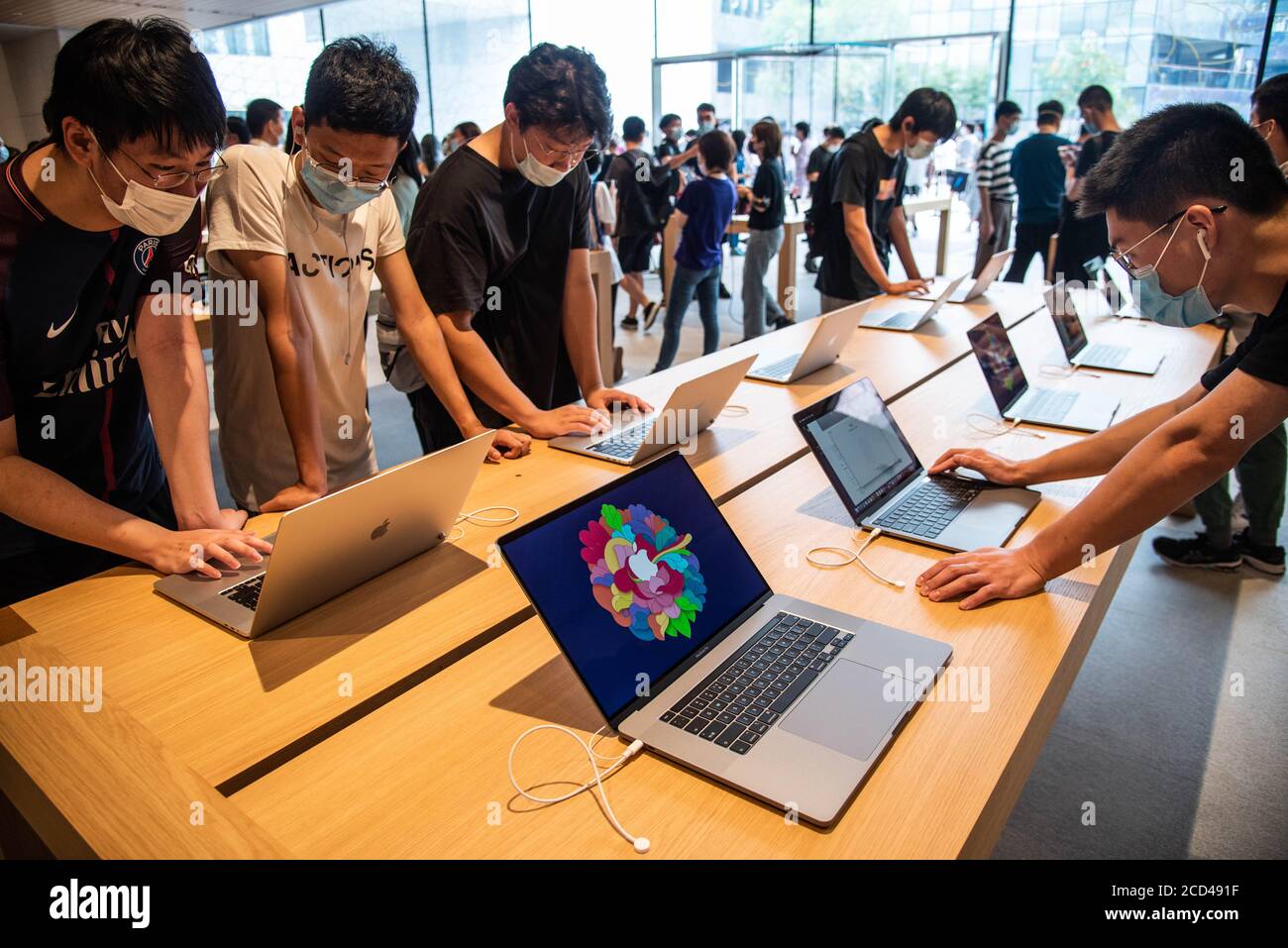 People experience Apple products at the newly-opened Apple Store at ...