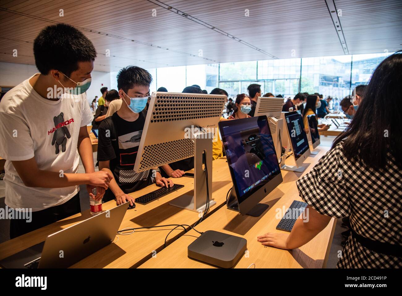 People experience Apple products at the newly-opened Apple Store at ...