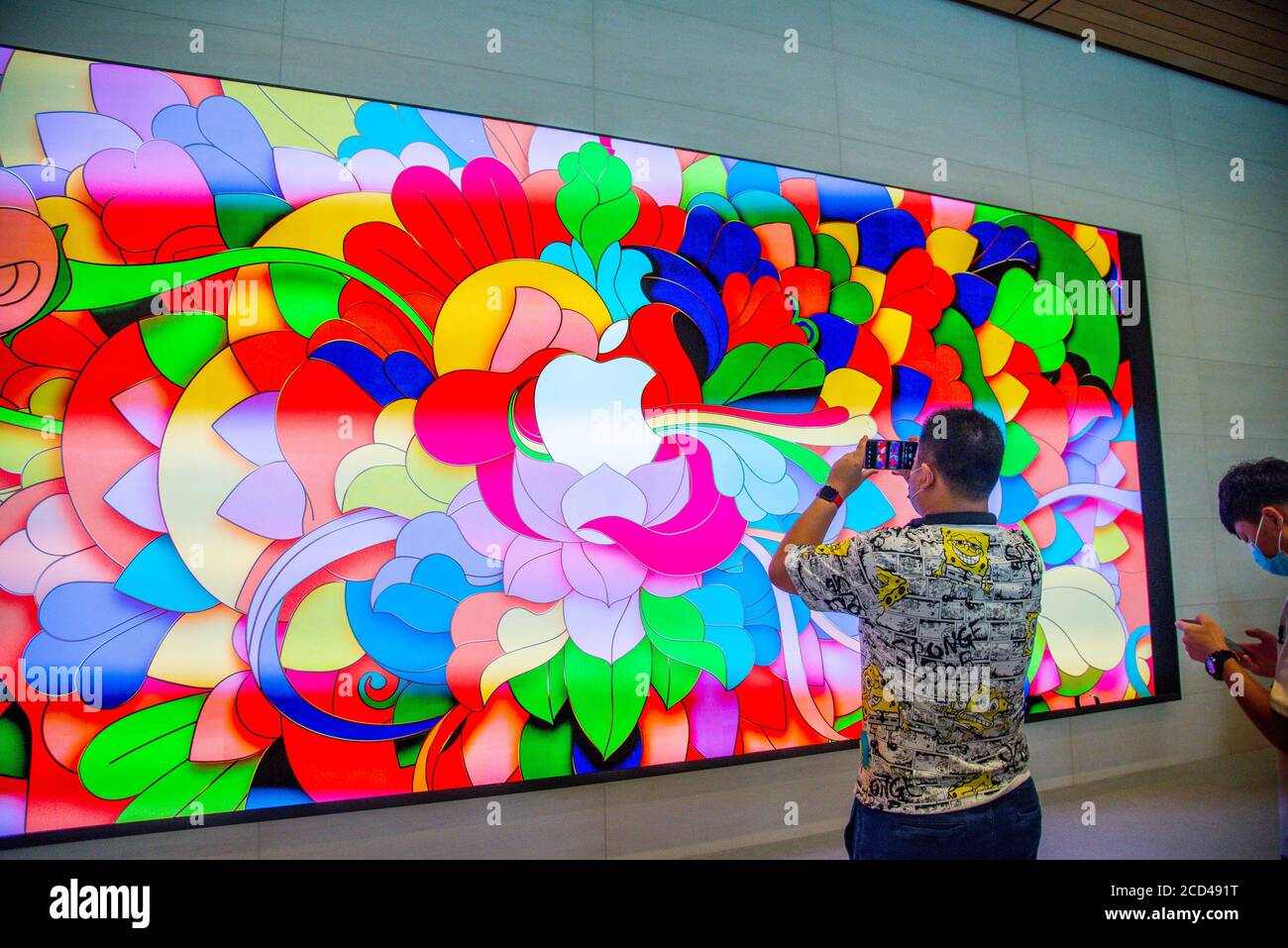 People take photos of Apple logo at the newly-opened Apple Store at ...