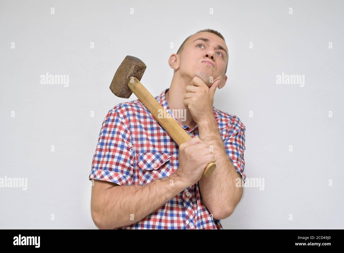 Man with a sledgehammer on a white background. Work concept Stock Photo ...