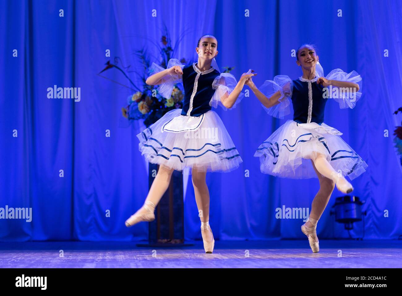 Young girls ballerina in a blue and white costume dancing ballet ...