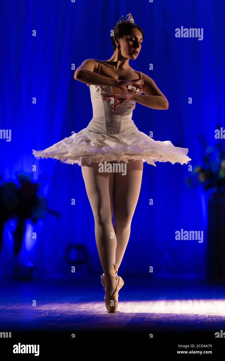 Young girl ballerina in a light blue dress tutu dancing performance of ...