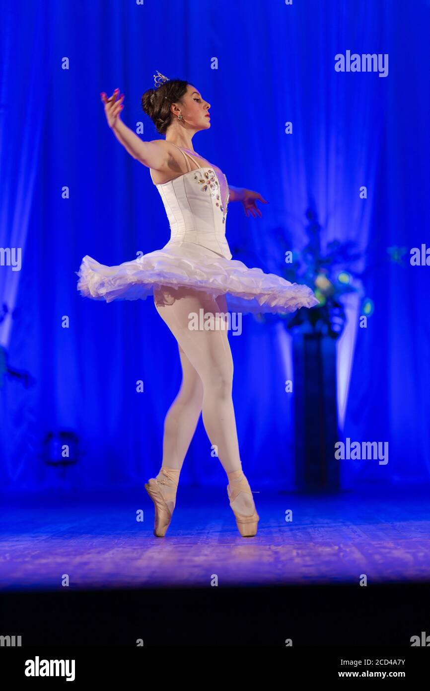 Young girl ballerina in a light blue dress tutu dancing performance of ...