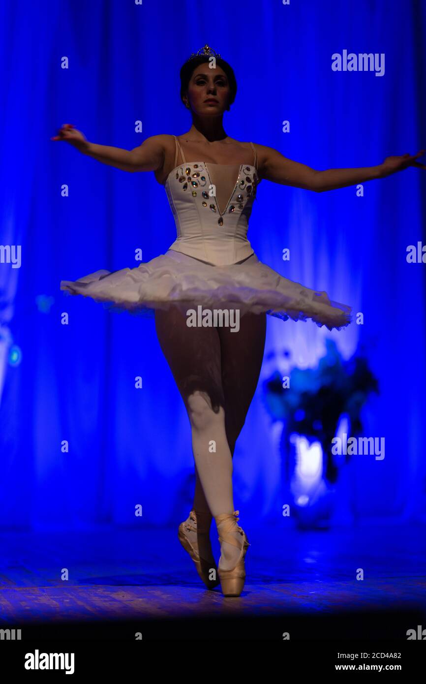 Young girl ballerina in a light blue dress tutu dancing performance of ...