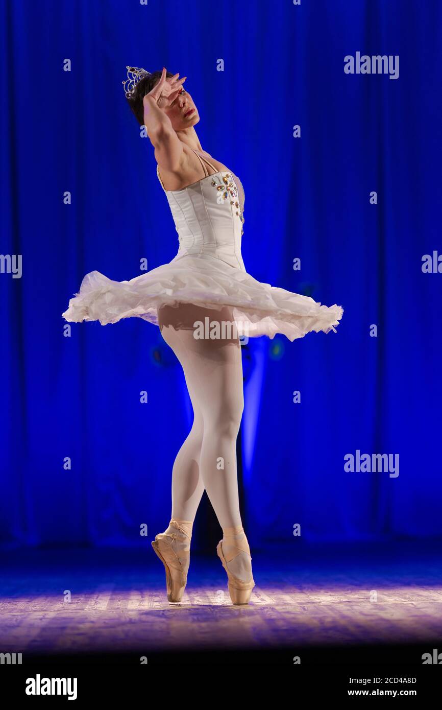 Young girl ballerina in a light blue dress tutu dancing performance of ...